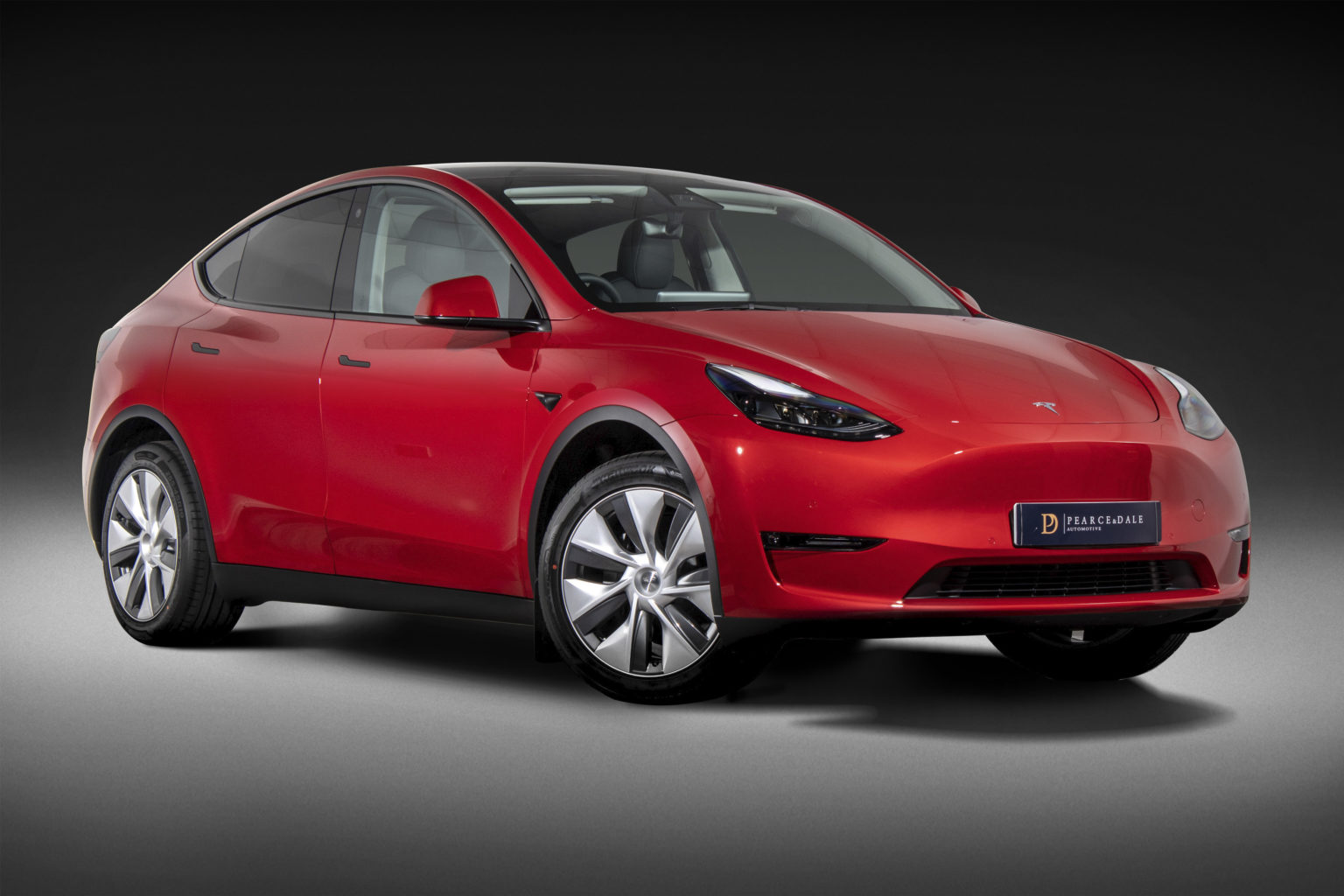Tesla Model Y Red black background - Pearce & Dale